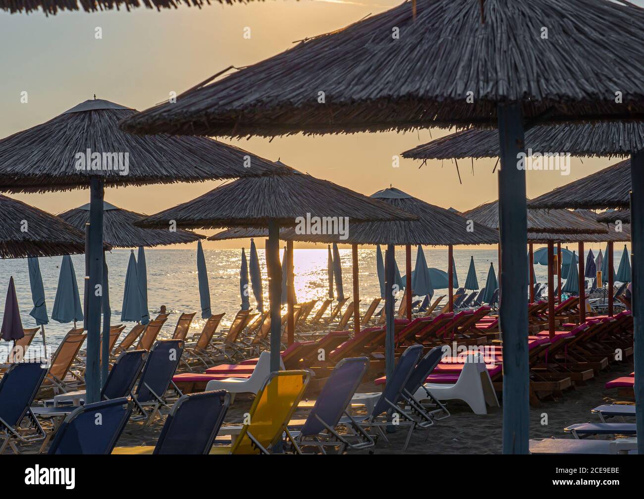 sunset beach with umbrellas and sunbeds without tourists Stock Photo ...