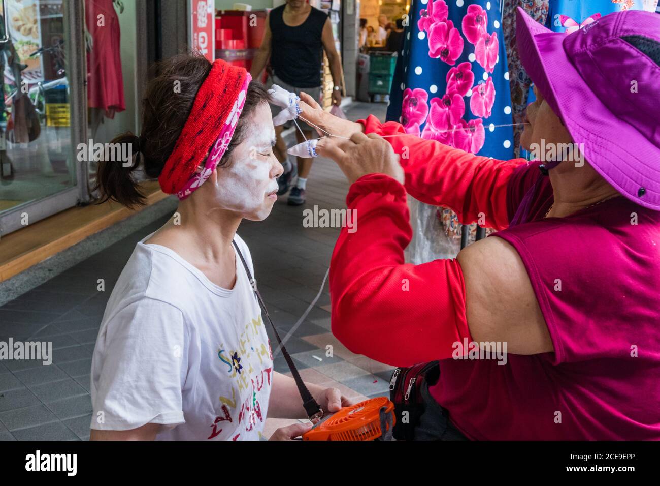 NEW TAIPEI CITY, TAIWAN - JULY 23: Unidentified woman gets a ...