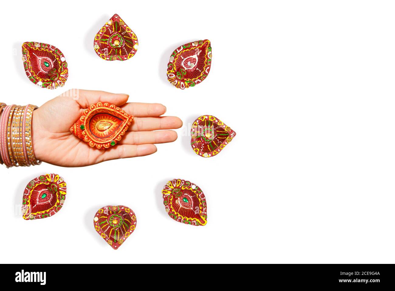 Happy Diwali - Woman hands with henna holding lit candle isolated on ...
