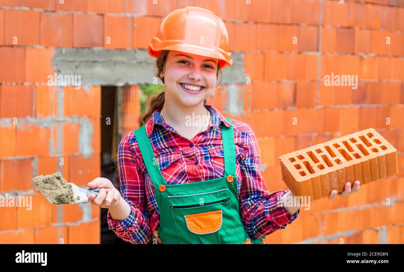 Architecture construction child. Child in uniform working around brick ...