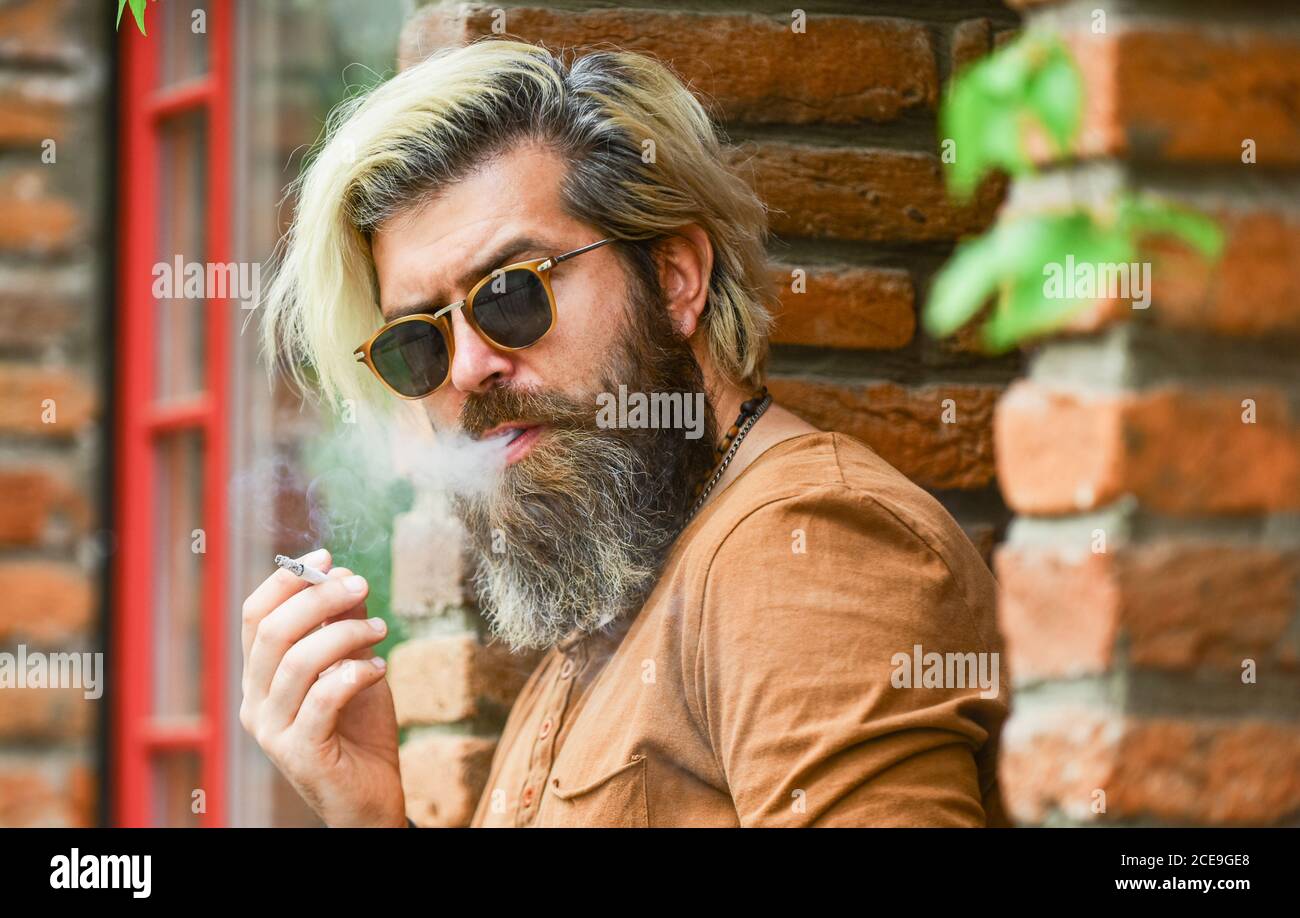 Smoking outdoors. Smoking habit. Fashionable mature man with cigarette ...