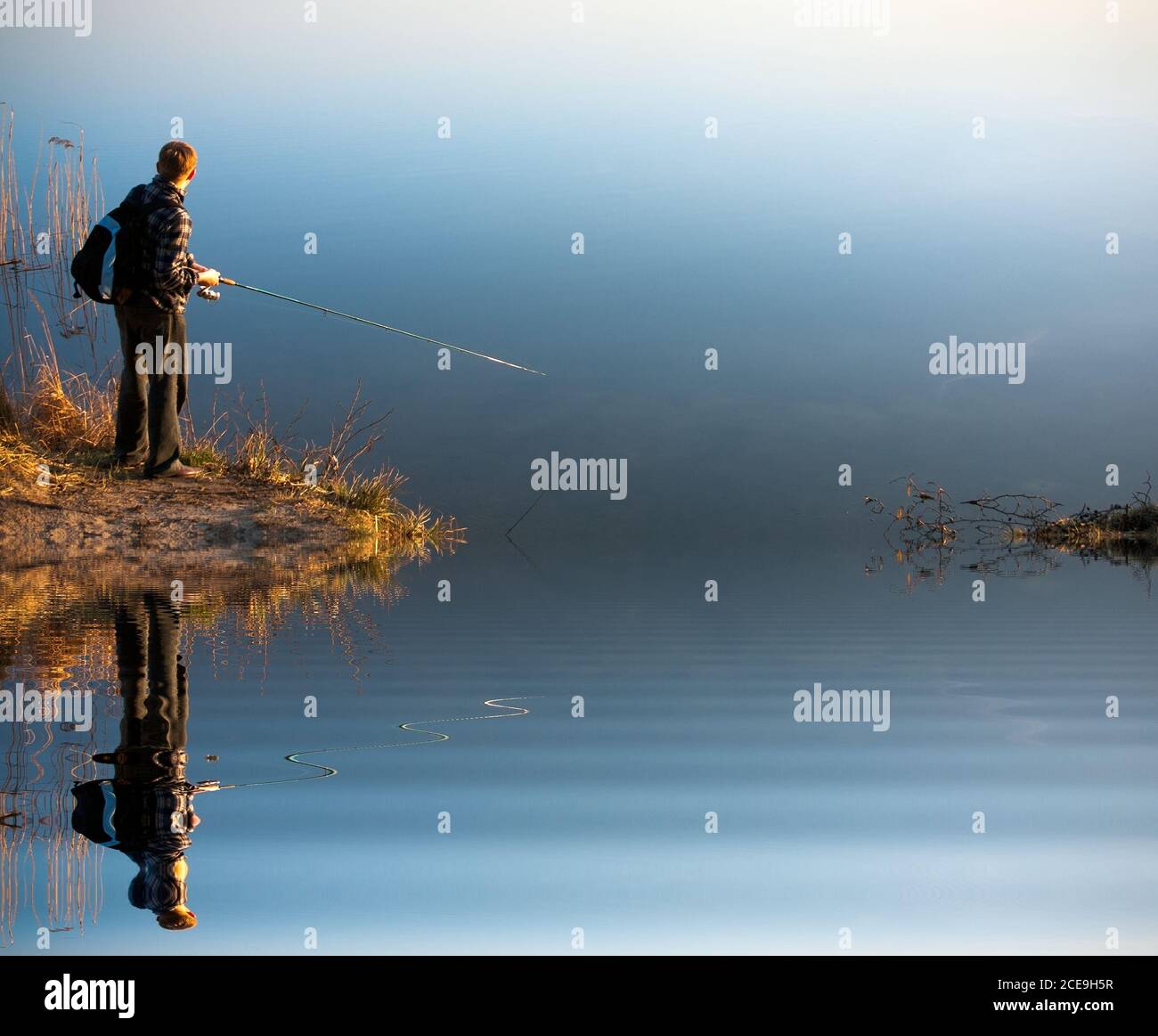 Fishing in a lake Stock Photo - Alamy