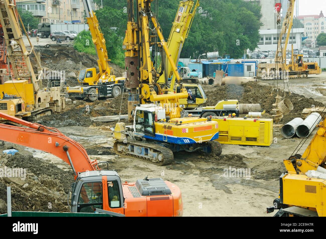 Construction site with yellow tractors Stock Photo - Alamy