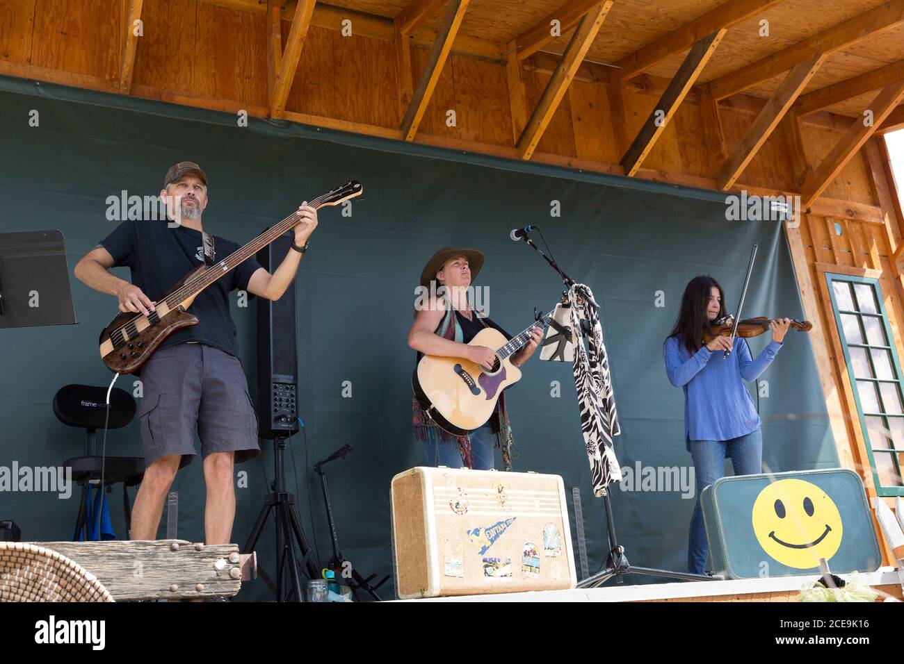 SALLY NEWSOME-LADD (center), accompanied by JOHN COTTON on guitar and ...