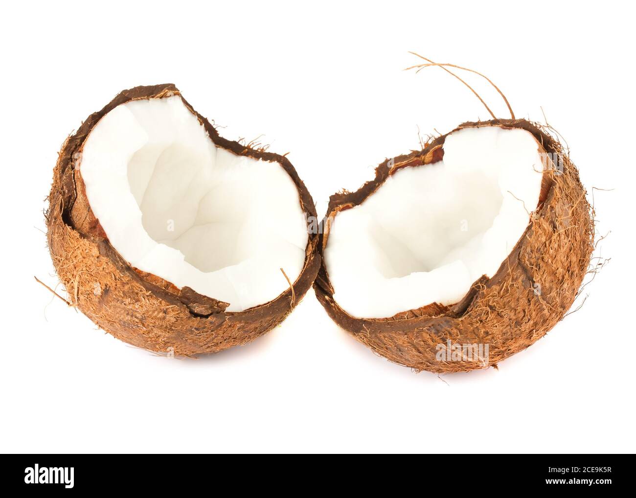 Two halves of coconut on white background Stock Photo - Alamy