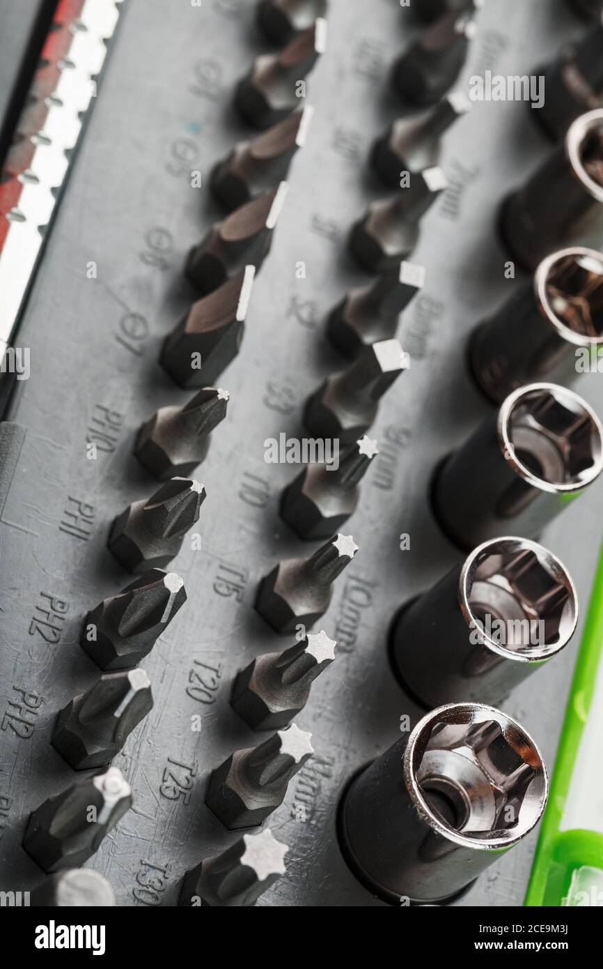 Tool box with attachments and bits of different shapes and sizes close ...