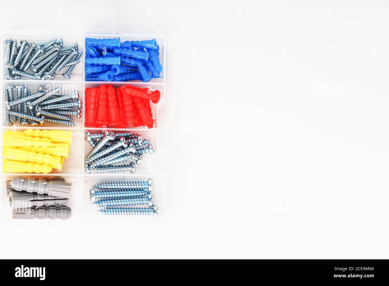 Screws and dowels of various sizes, types and colors in a transparent ...