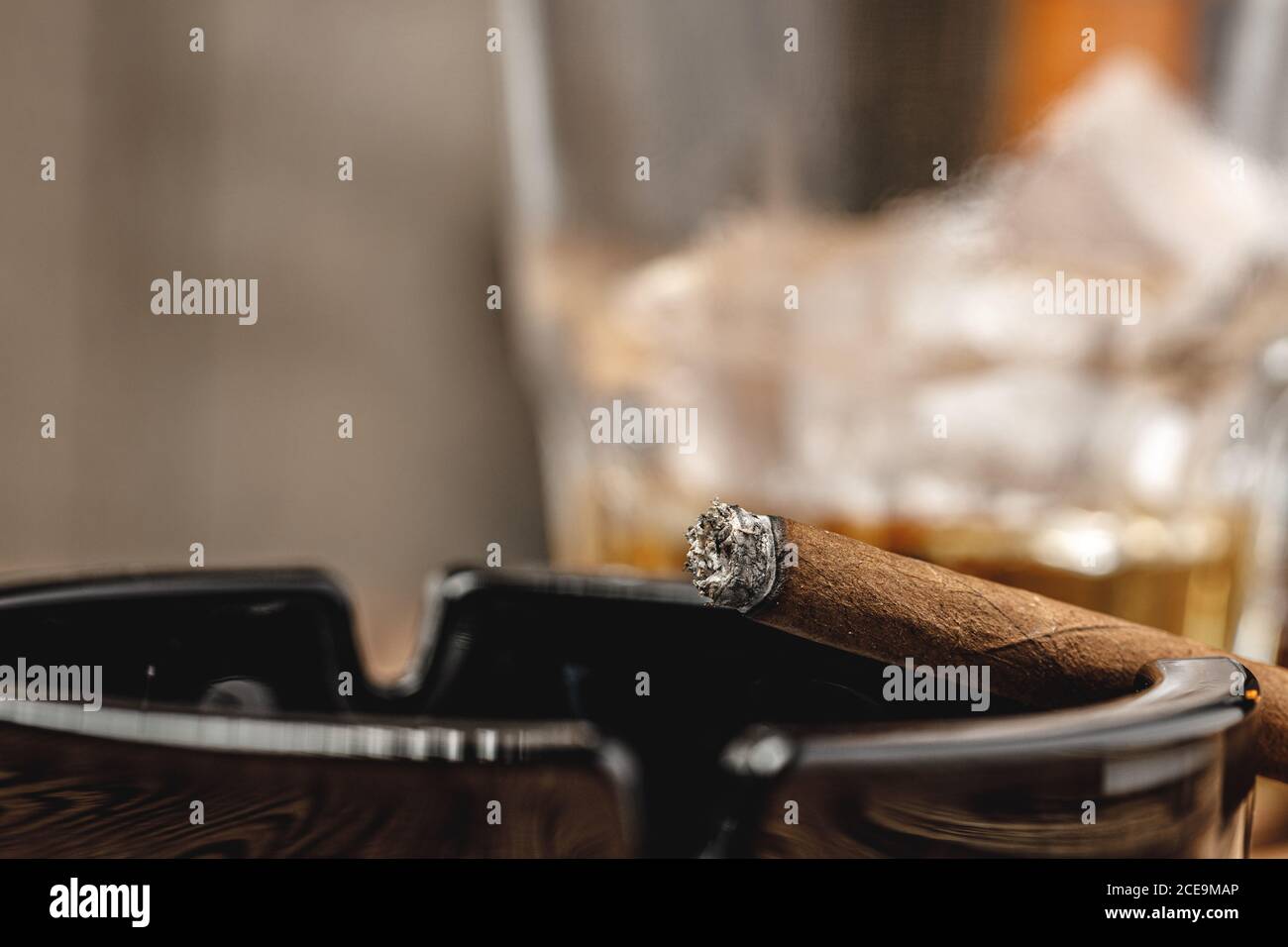 Lighted cigar in an ashtray close up Stock Photo - Alamy