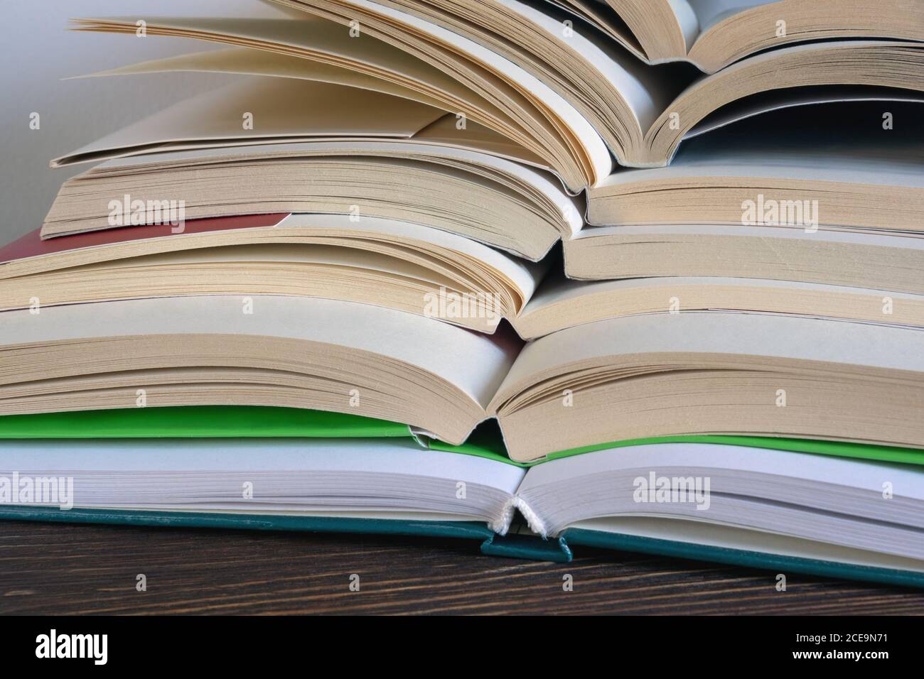 Vertical stack of open books Stock Photo - Alamy