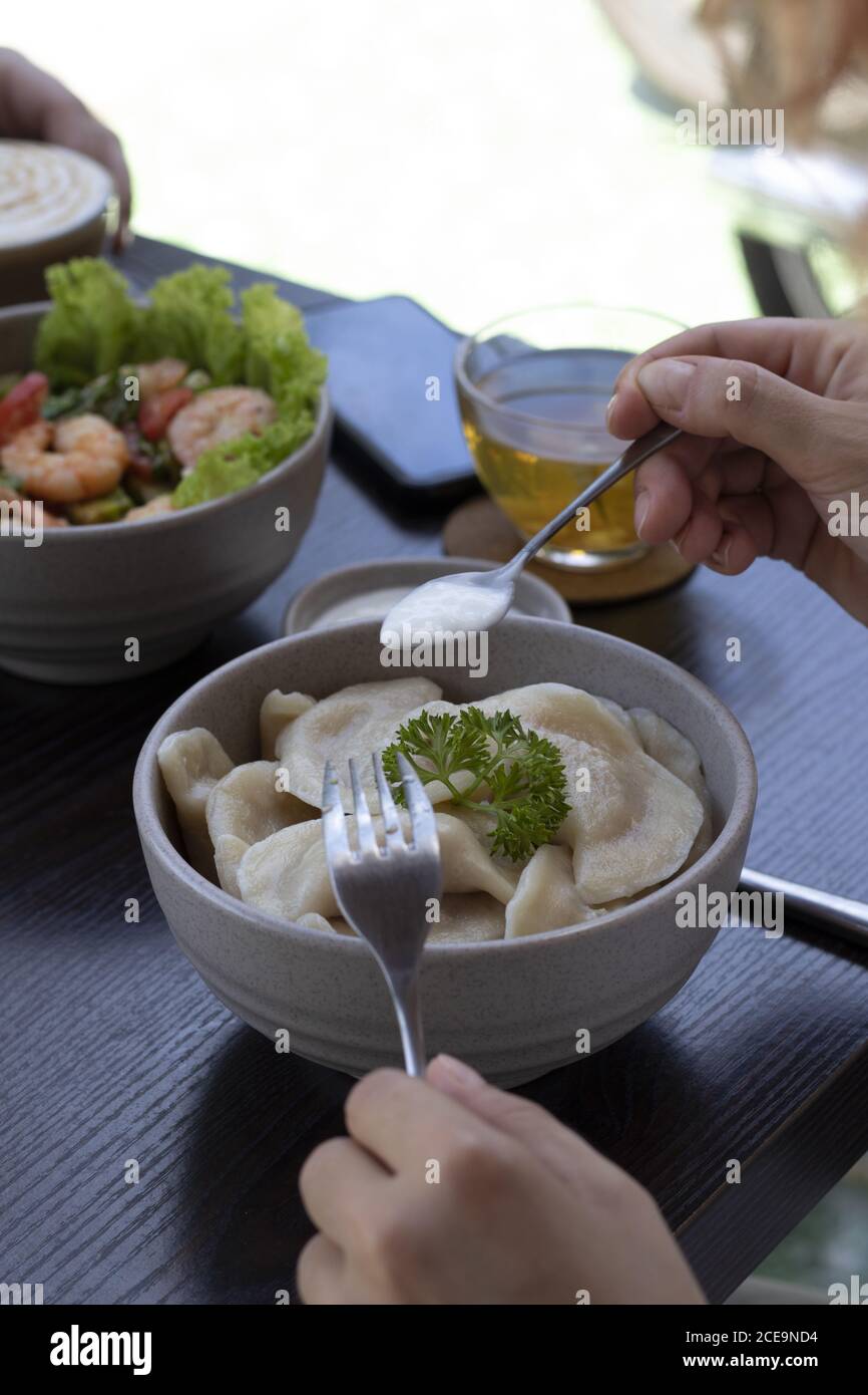 Vertical closeup shot of a man eating a bowl of traditional Russian ...