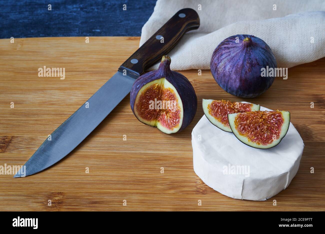 Fruit of figs, cheese Bree and a knife on a bamboo board Stock Photo ...