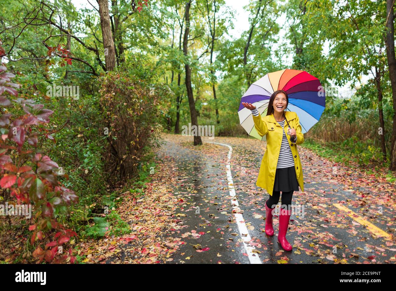 Asian Autumn woman happy after rain walking with umbrella. Female model ...