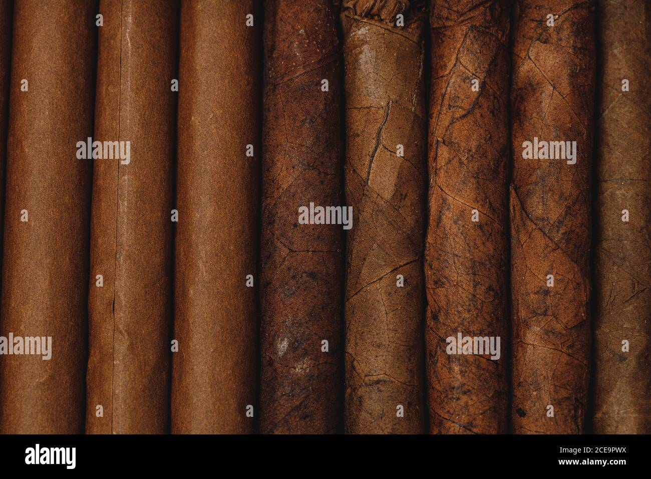 Background of stacked rolled cigars close up Stock Photo - Alamy