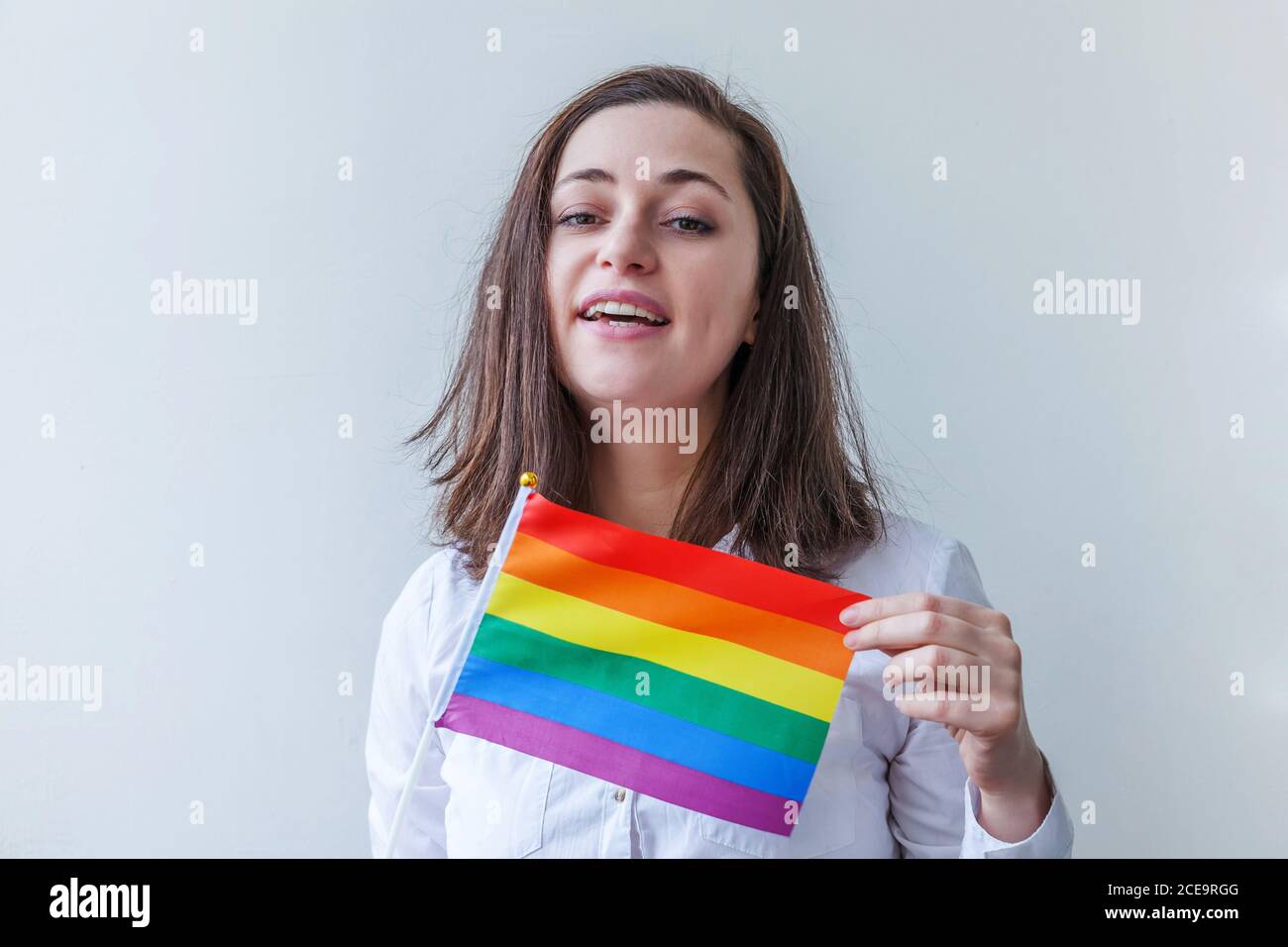 Beautiful caucasian lesbian girl with LGBT rainbow flag isolated on ...