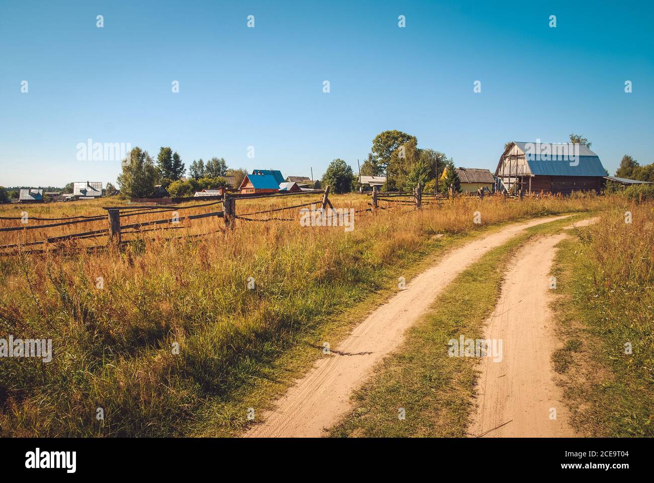 rural road stretching into the distance through the fields in the ...