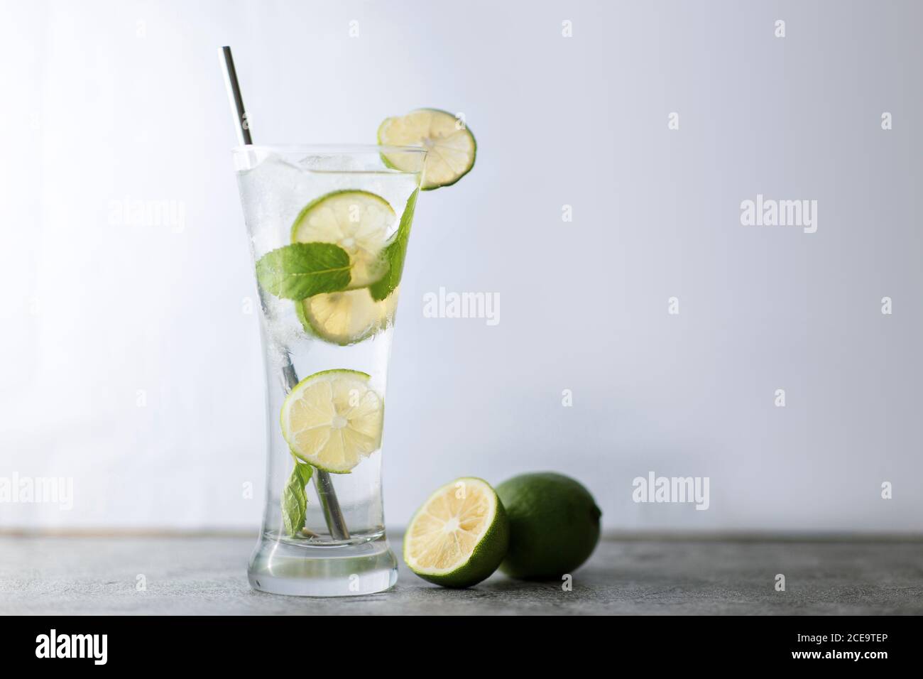 Cold refreshing beverage with sliced lime ripes and ice reverse light ...