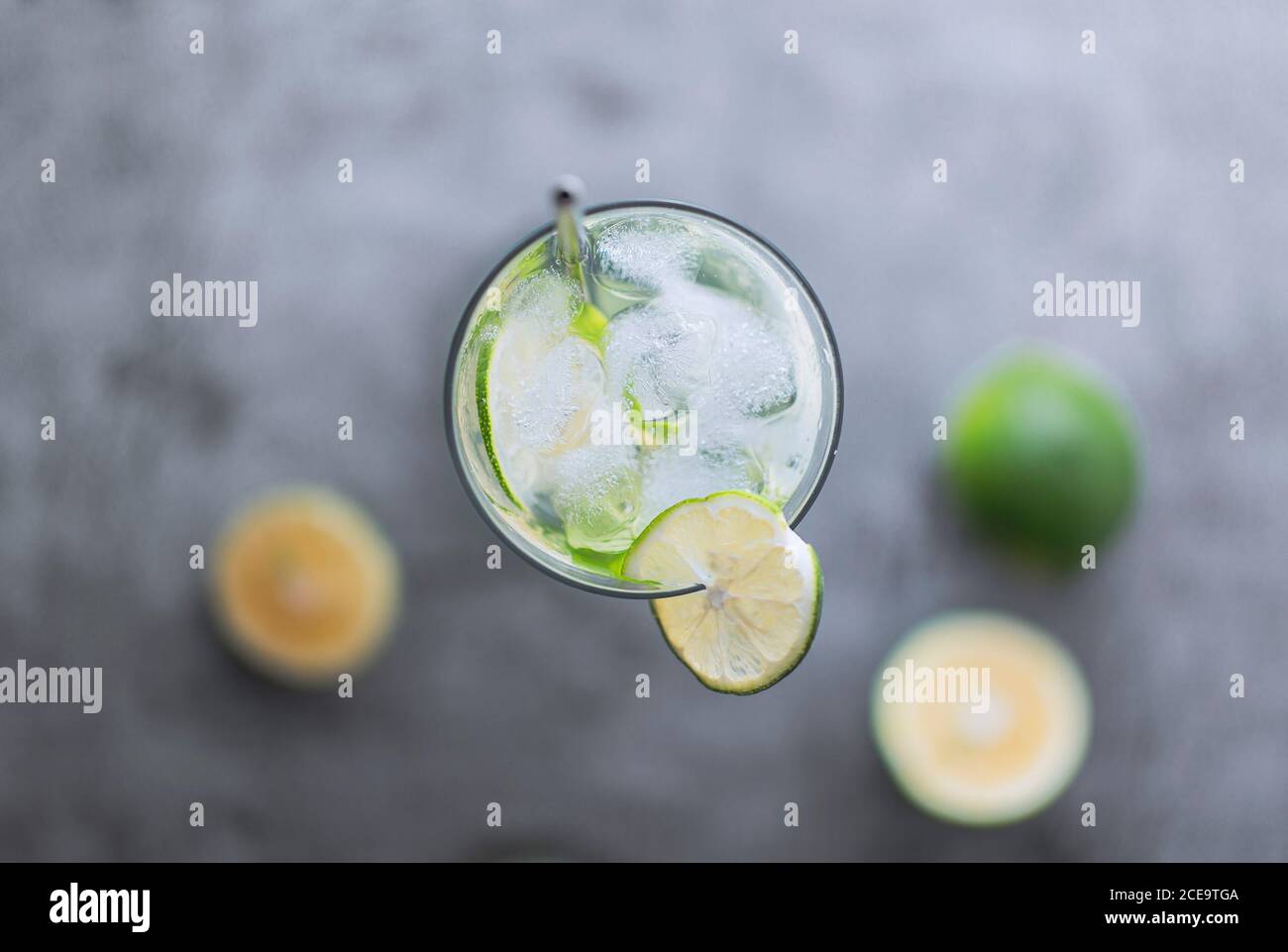 Flat lay top view of cold refreshing beverage with sliced lime ripes ...