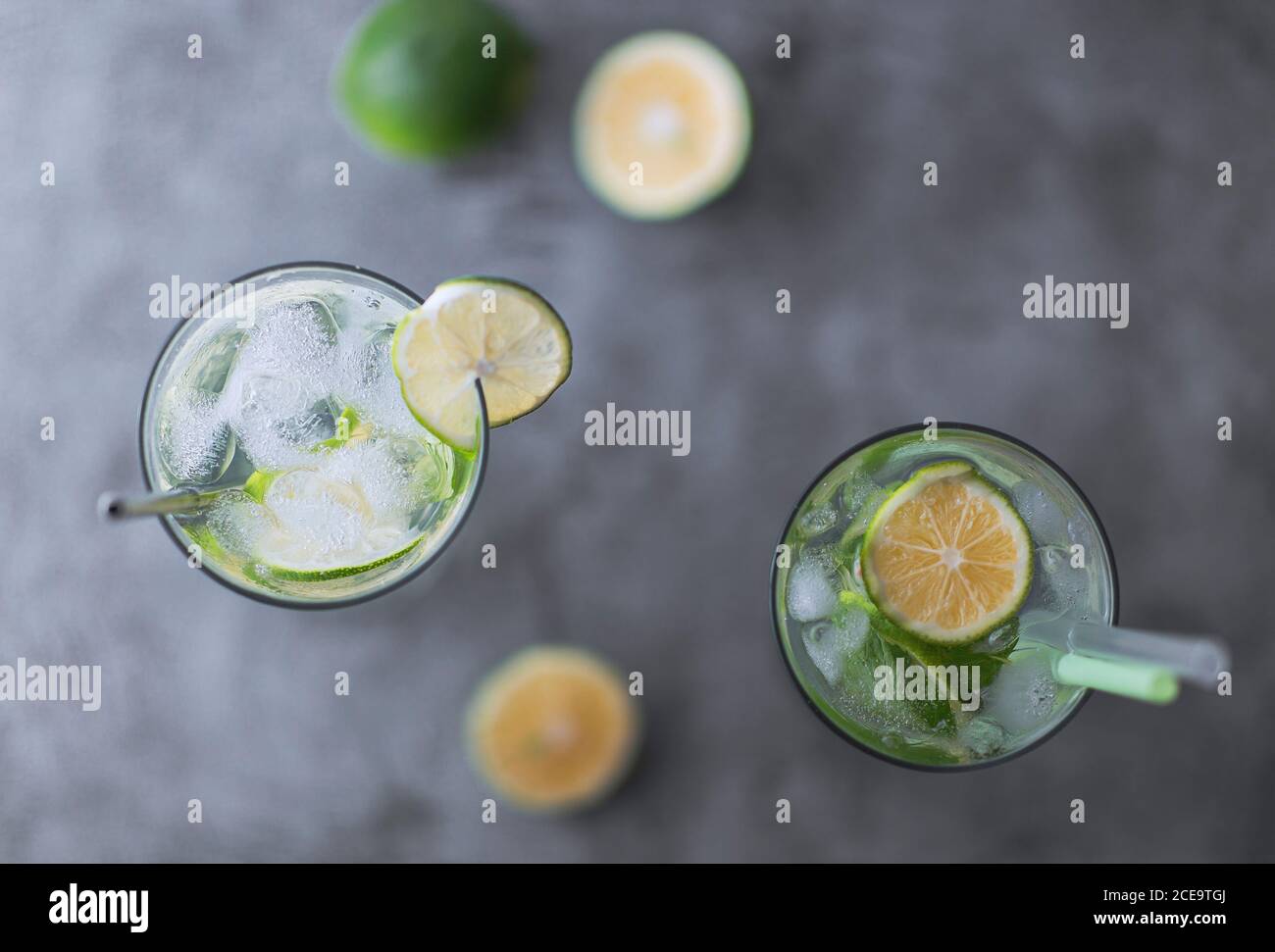 Flat lay top view of cold refreshing beverage with sliced lime ripes ...