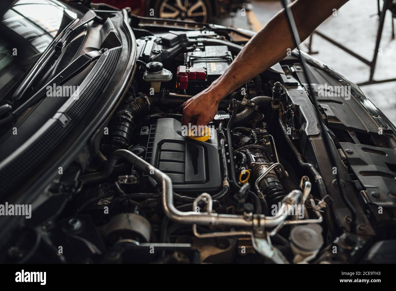 Closeup shot of auto mechanic hands doing a car technical inspection in ...