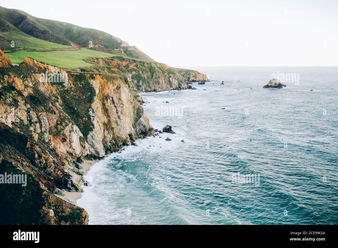 The cliff with the green meadow and the ocean. Horizontal outdoors shot ...