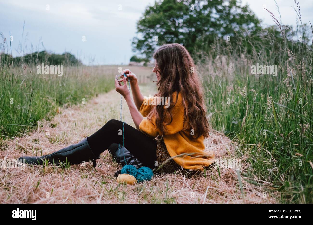 Side view of female binding in the meadow Stock Photo - Alamy