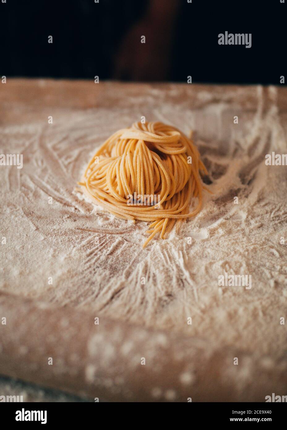 Tangled spaghetti on table with flour Stock Photo - Alamy