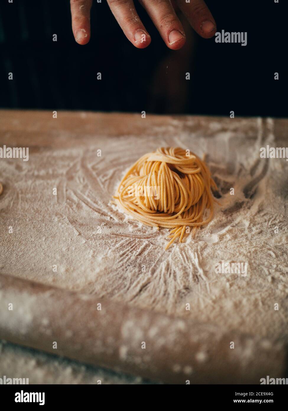 Tangled spaghetti on table with flour Stock Photo - Alamy
