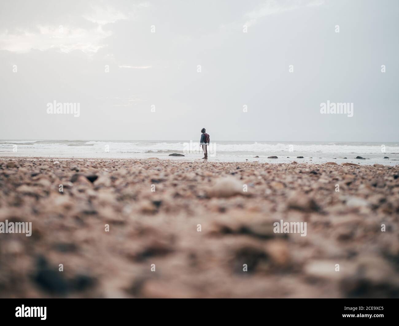 Tourist standing at calm ocean Stock Photo - Alamy