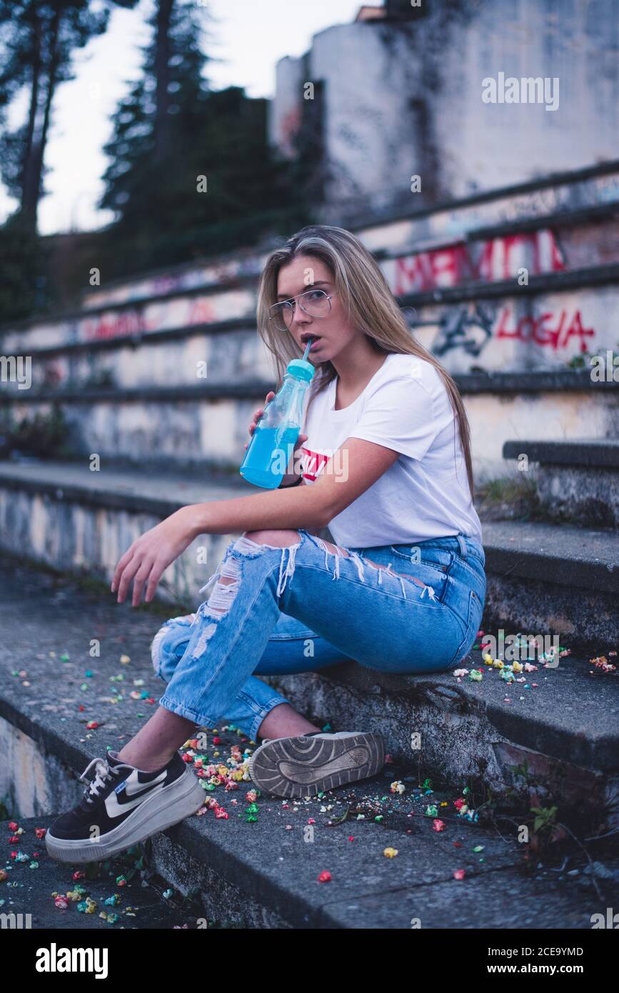 Beautiful lady sitting on stairs with snacks Stock Photo - Alamy