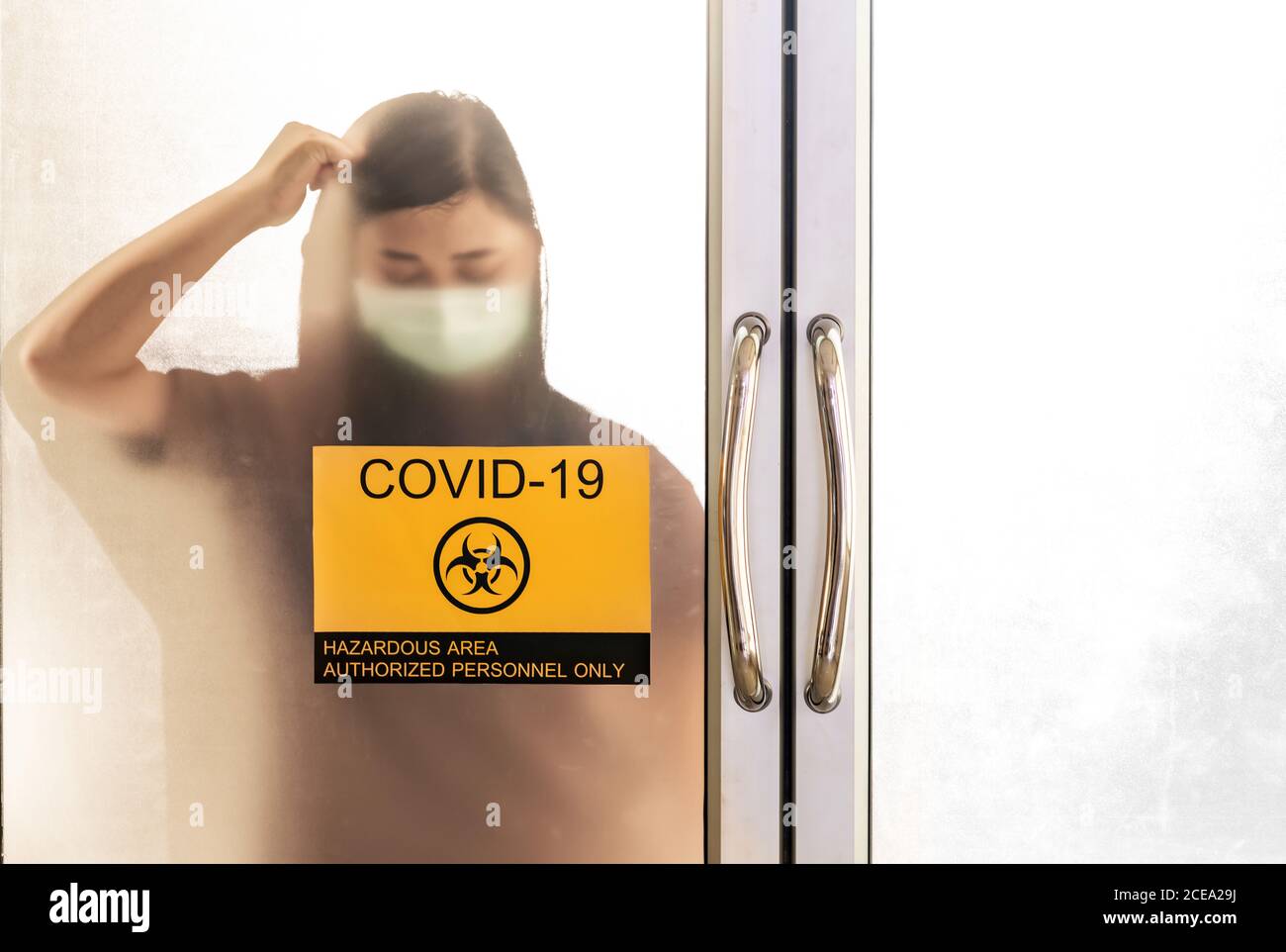 Signage of coronavirus COVID-19 quarantine zone and Silhouette of asian ...