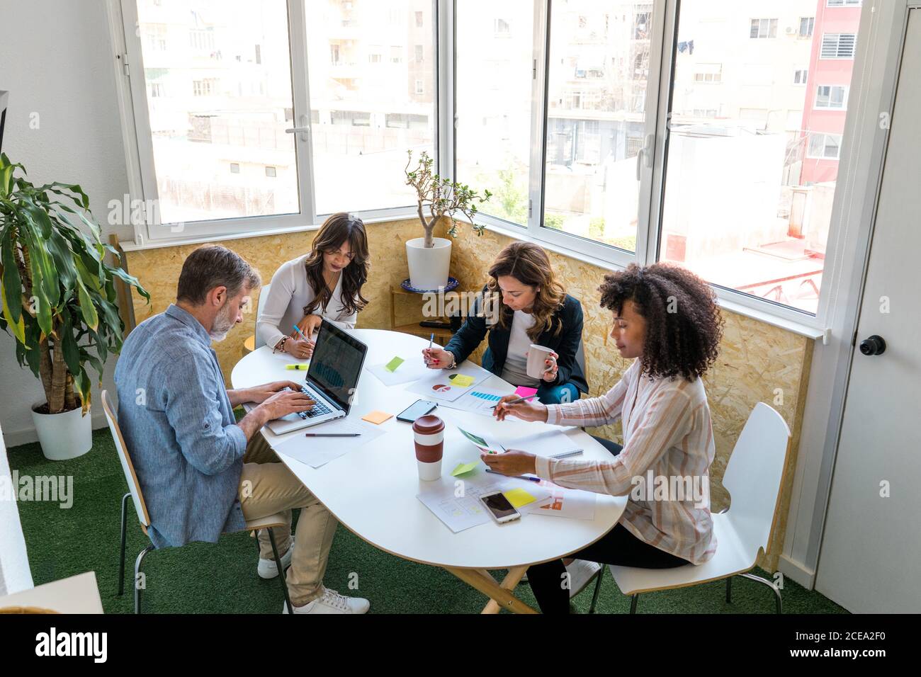 Colleagues communicating during work Stock Photo - Alamy