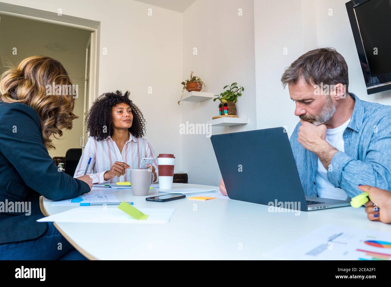Colleagues communicating during work Stock Photo - Alamy