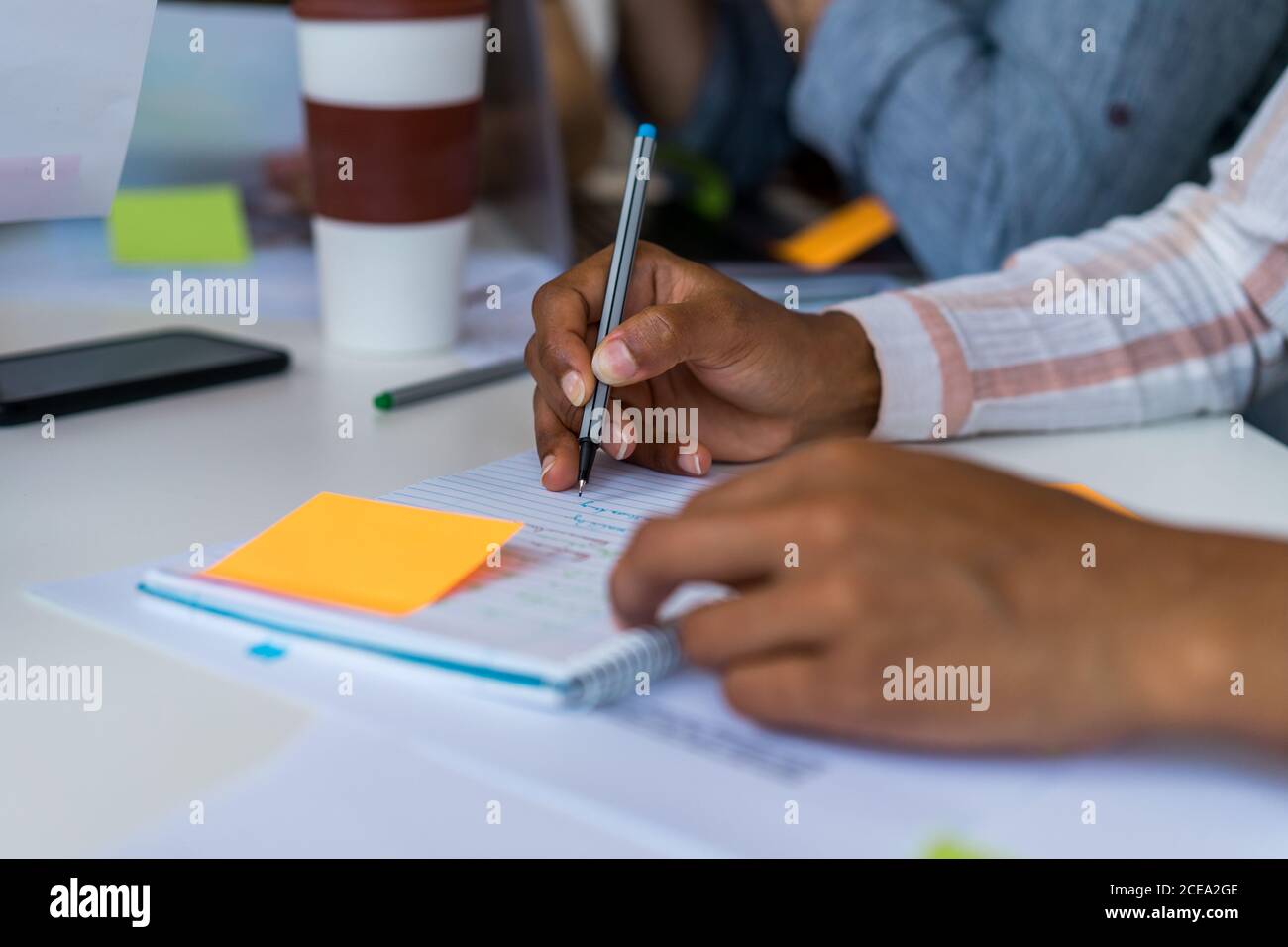 Crop hands marking items on scheme Stock Photo - Alamy