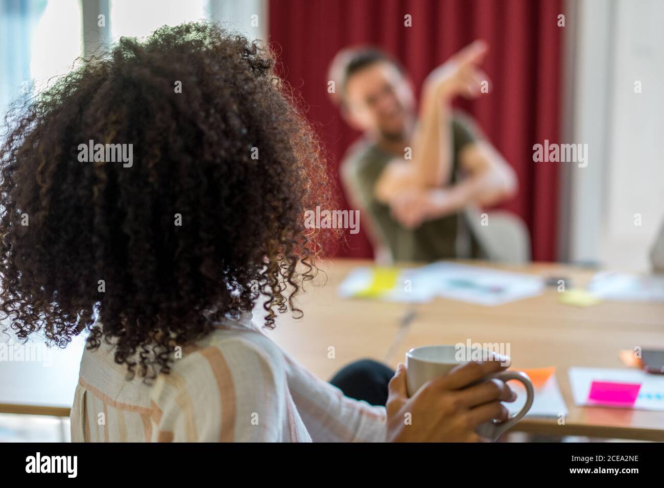 Back view woman listening unrecognizable hi-res stock photography and ...