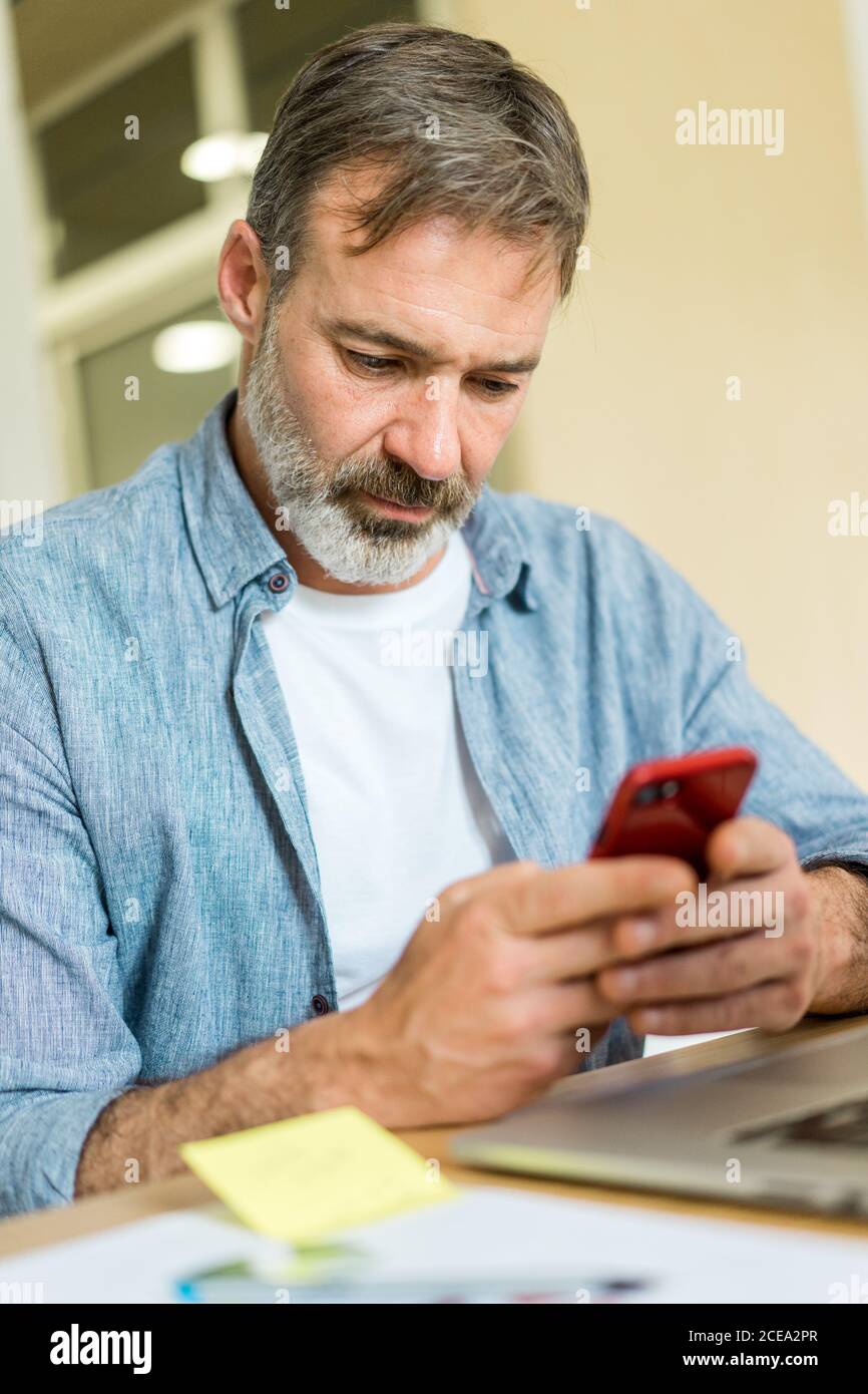 Man browsing smartphone sitting on hi-res stock photography and images ...