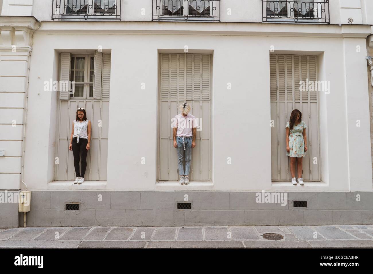 Friends standing on window sill Stock Photo - Alamy