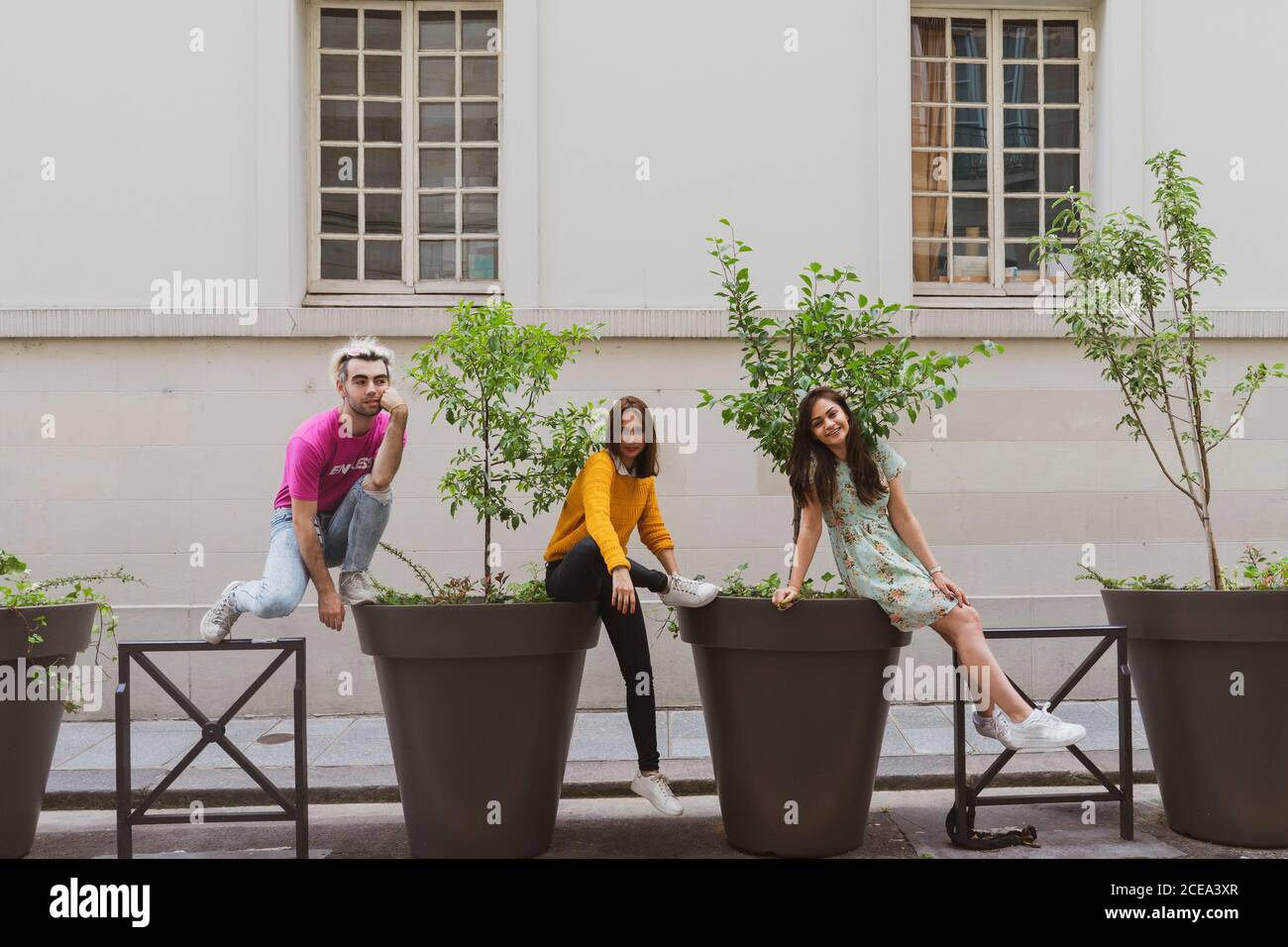 Happy friends jumping on street Stock Photo - Alamy