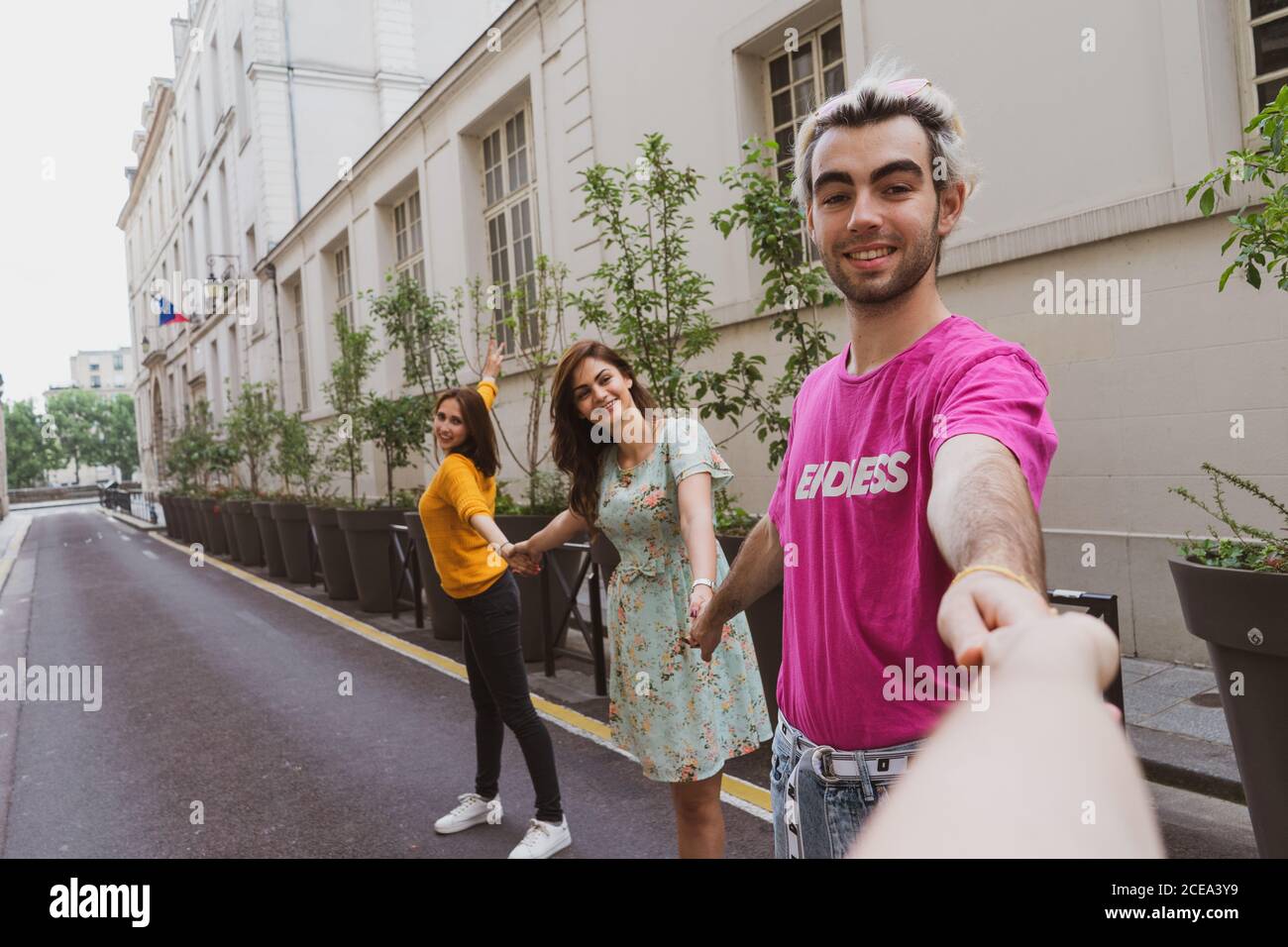 Happy friends holding hands Stock Photo - Alamy
