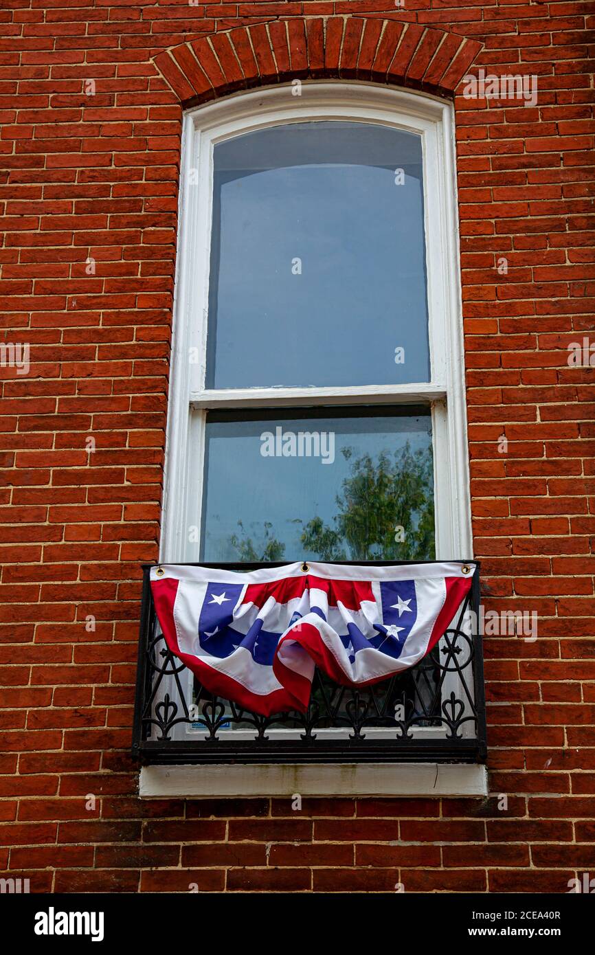 A narrow vertical arched window with wooden frame located on a vintage ...