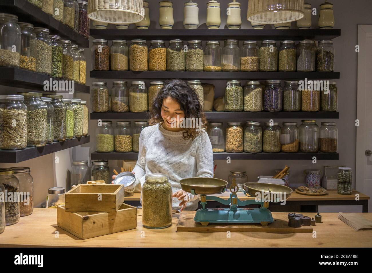 Woman opening jar with spices Stock Photo - Alamy