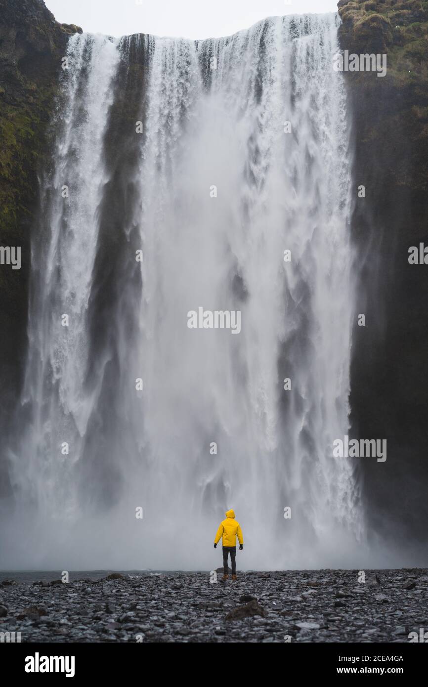back view of man near waterfall Stock Photo - Alamy