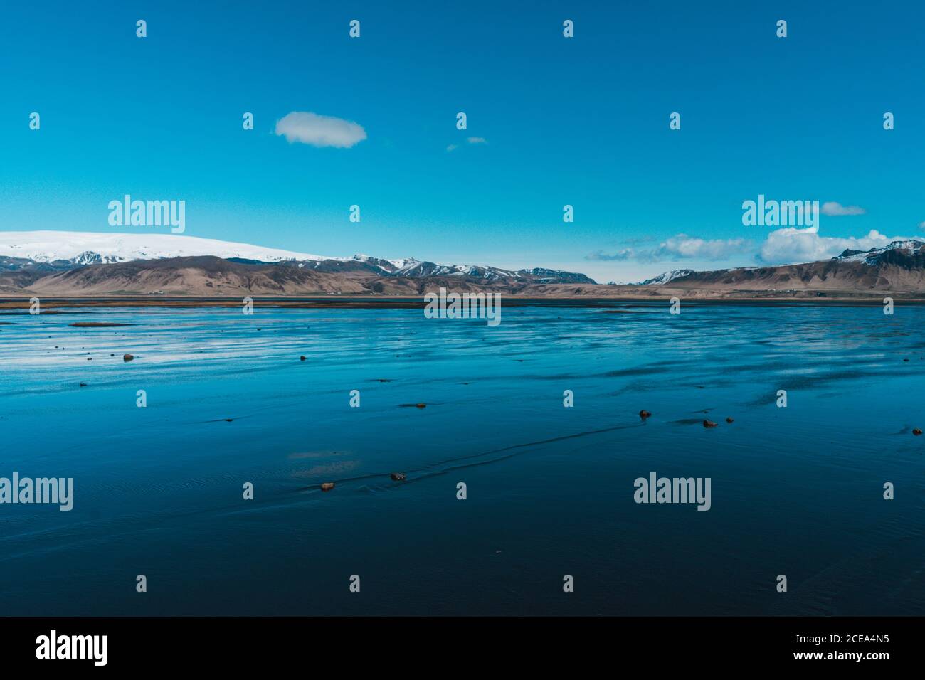 Beautiful landscape of low tide on coast with reflecting blue sky on ...