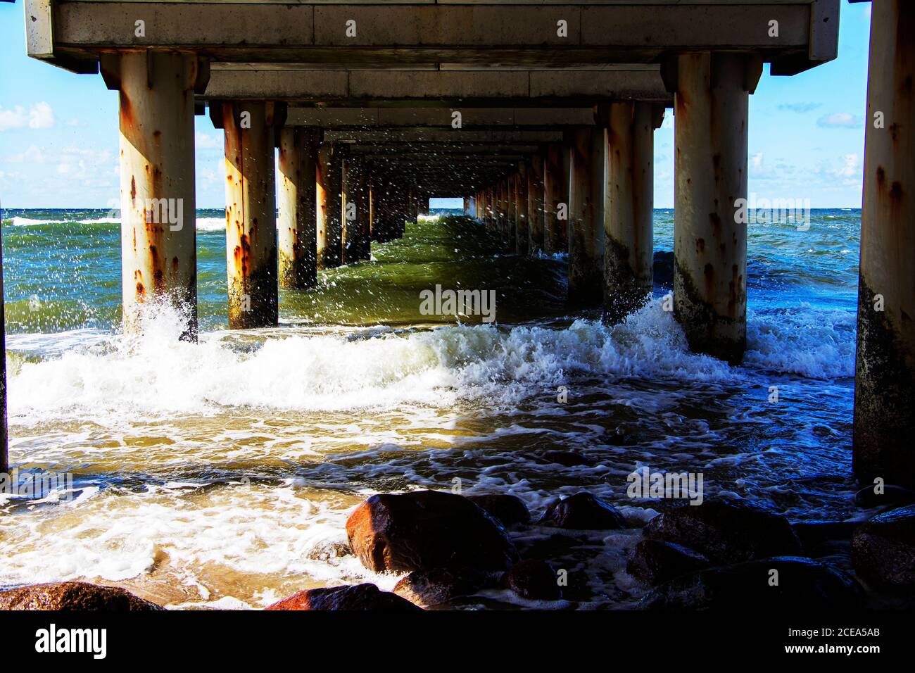Waves rumble under the pier, and the wave rolls Stock Photo - Alamy
