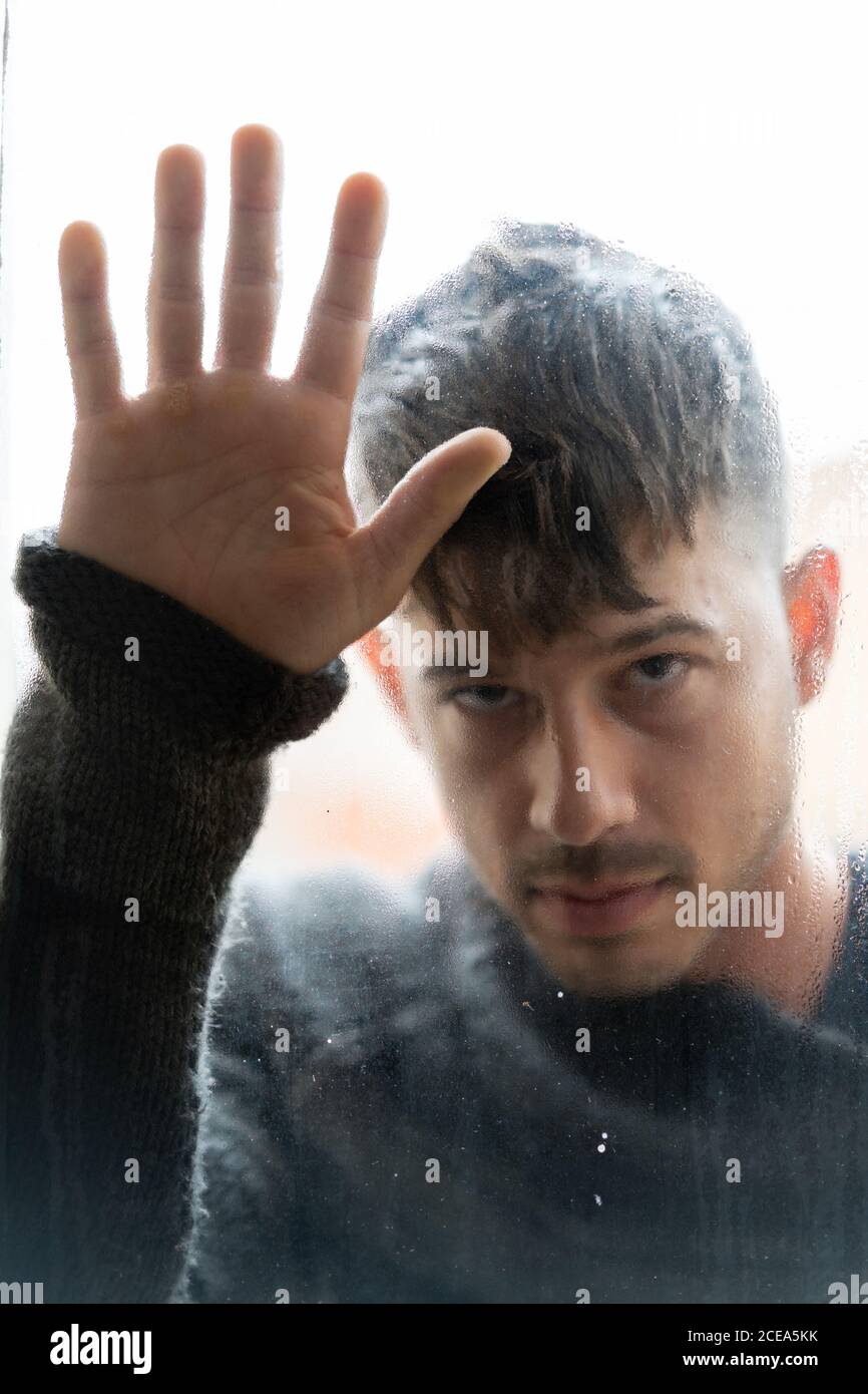 Hand behind glass hi-res stock photography and images - Alamy