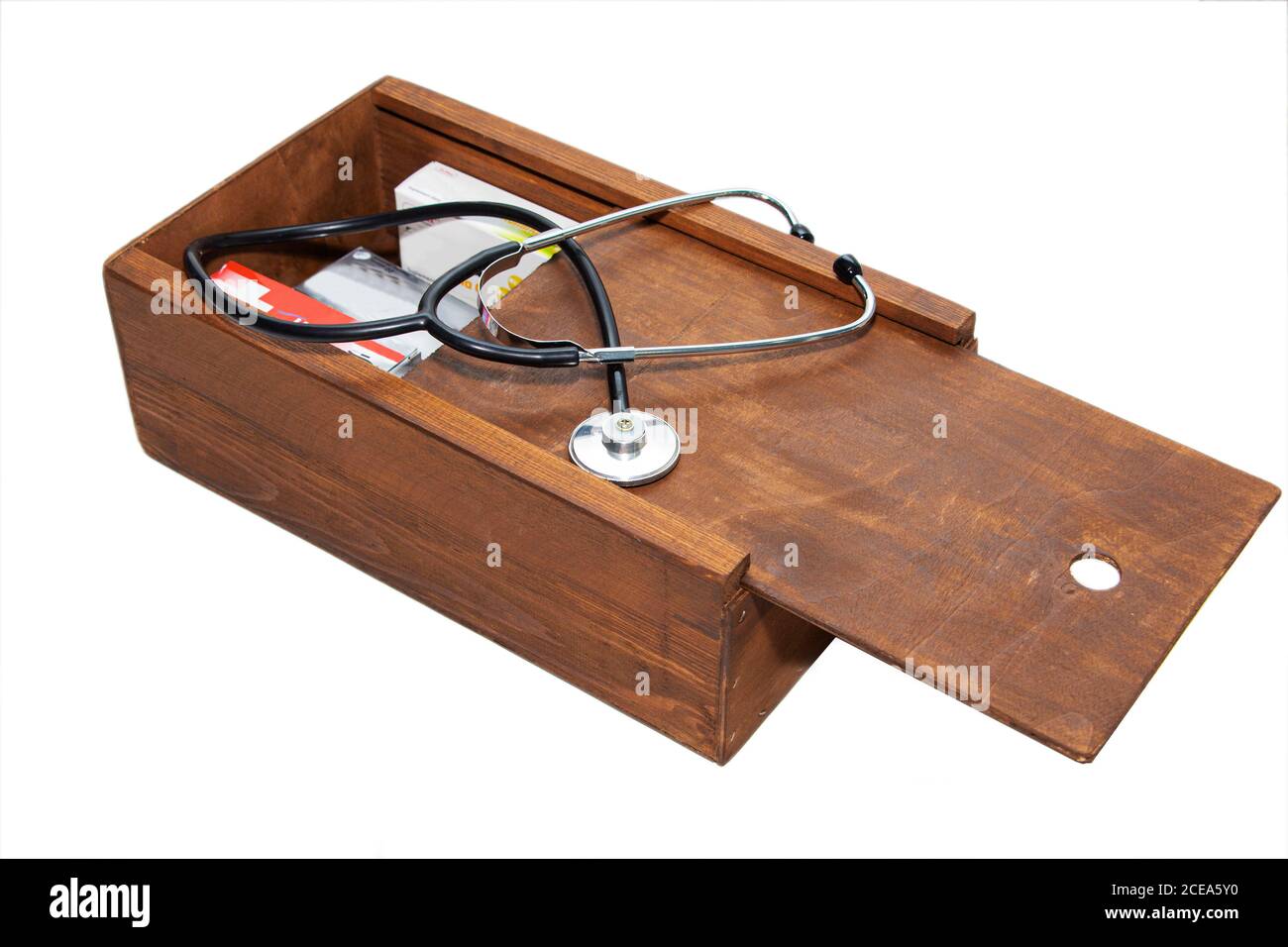 Wooden box inside the medicine. Home first aid kit on a light white ...