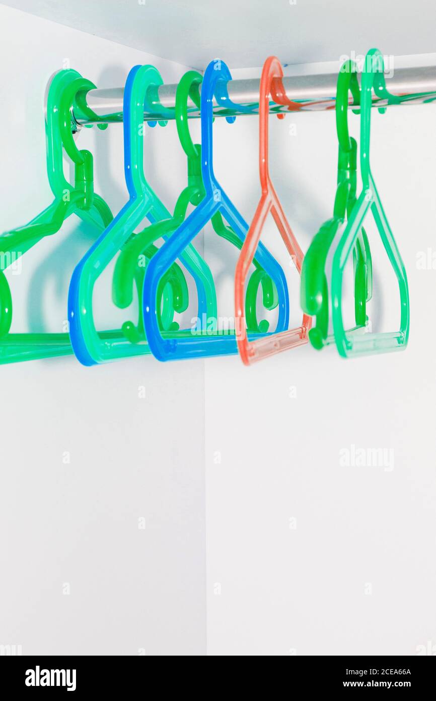 empty multi-colored clothes hangers on the rail, after sale Stock Photo ...