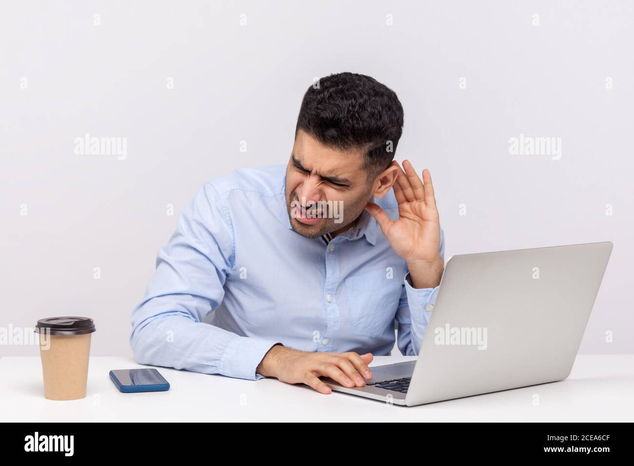 Confused businessman sitting office workplace, leaning towards laptop ...