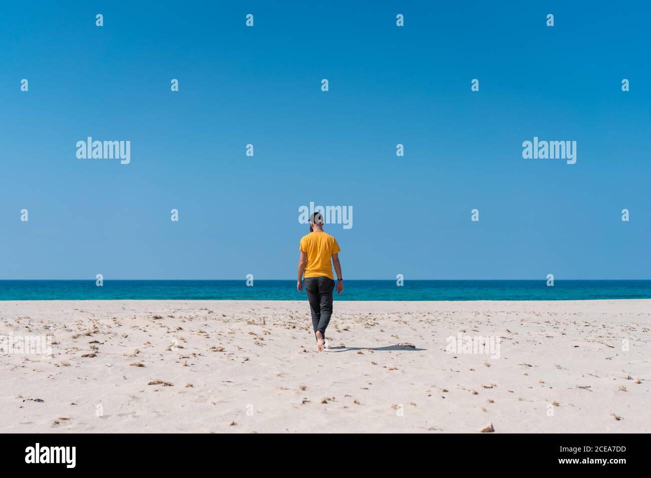 Side view of bearded man falling to sand on beach at the ocean Stock ...