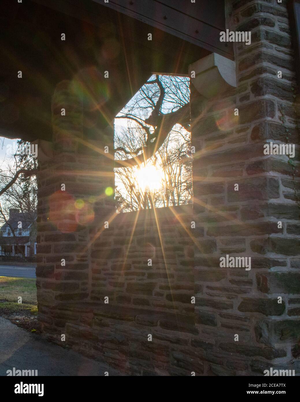 The Sun Shining Through a Window in a Cobblestone Wall in a Suburban ...
