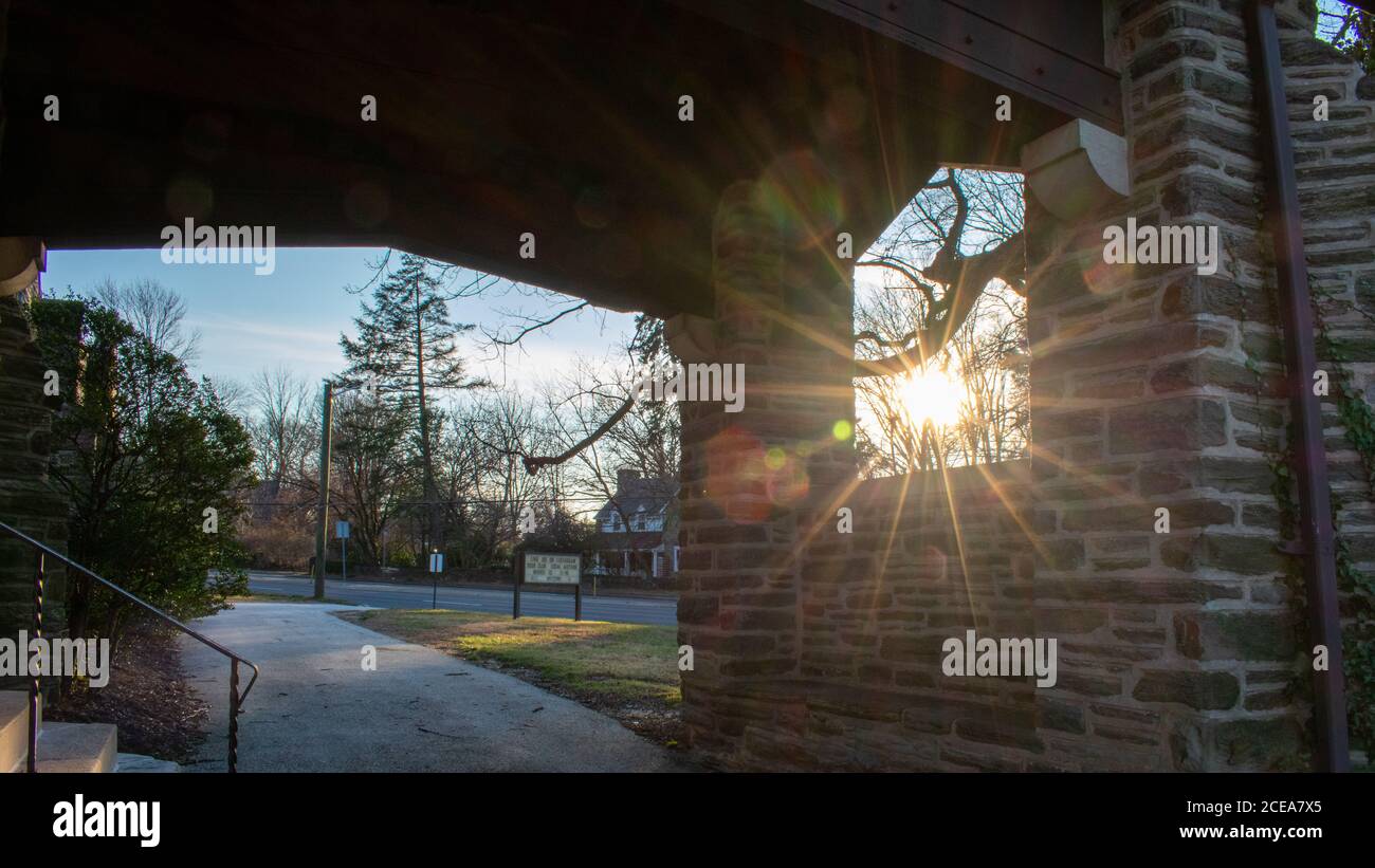 The Sun Shining Through a Window in a Cobblestone Wall in a Suburban ...